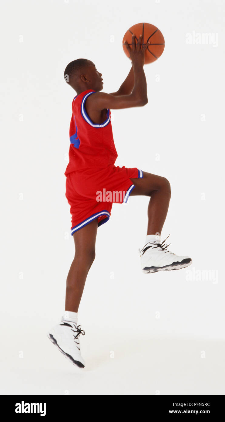 Boy leaving floor as he executes lay-up shot Stock Photo - Alamy