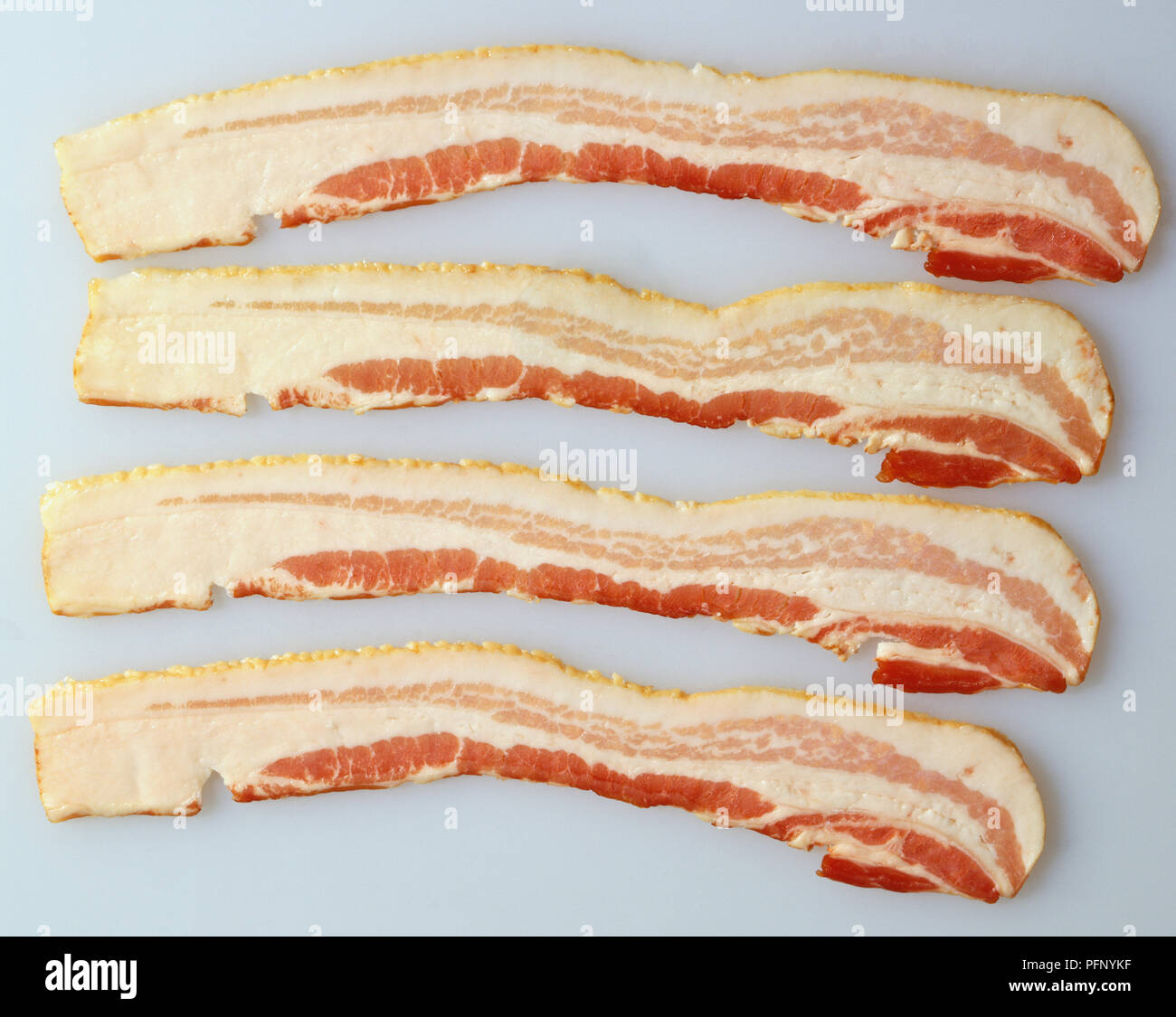 Four rashers of streaky bacon, view from above Stock Photo - Alamy