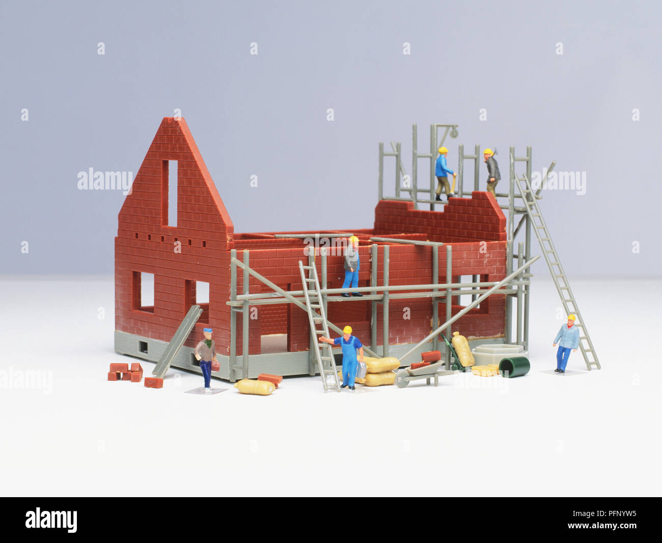 Model of a half-built house with scaffolding and toy workmen Stock ...
