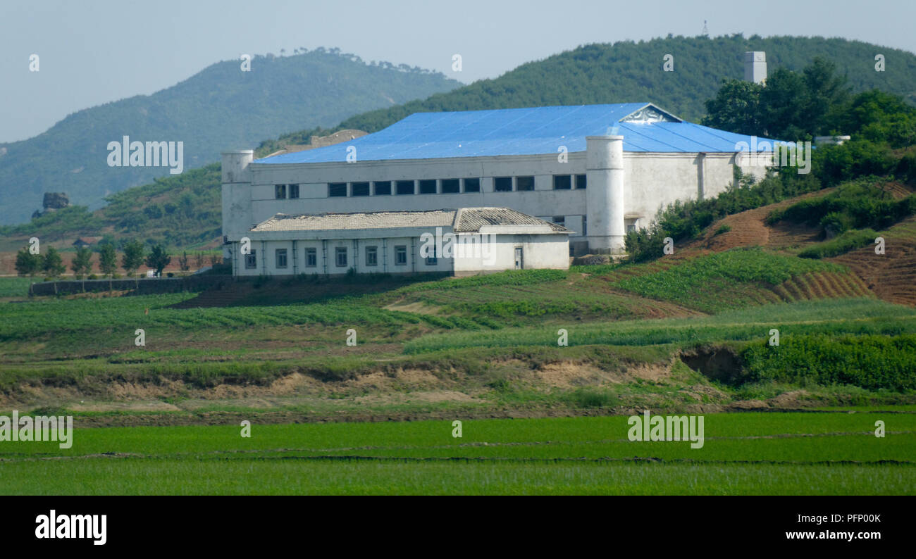 North Korea - an empty looking building in the rice fields that may be ...