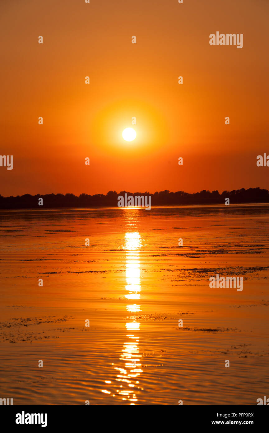 sunset in the Danube delta Romania.Beautiful blueish lights in water ...