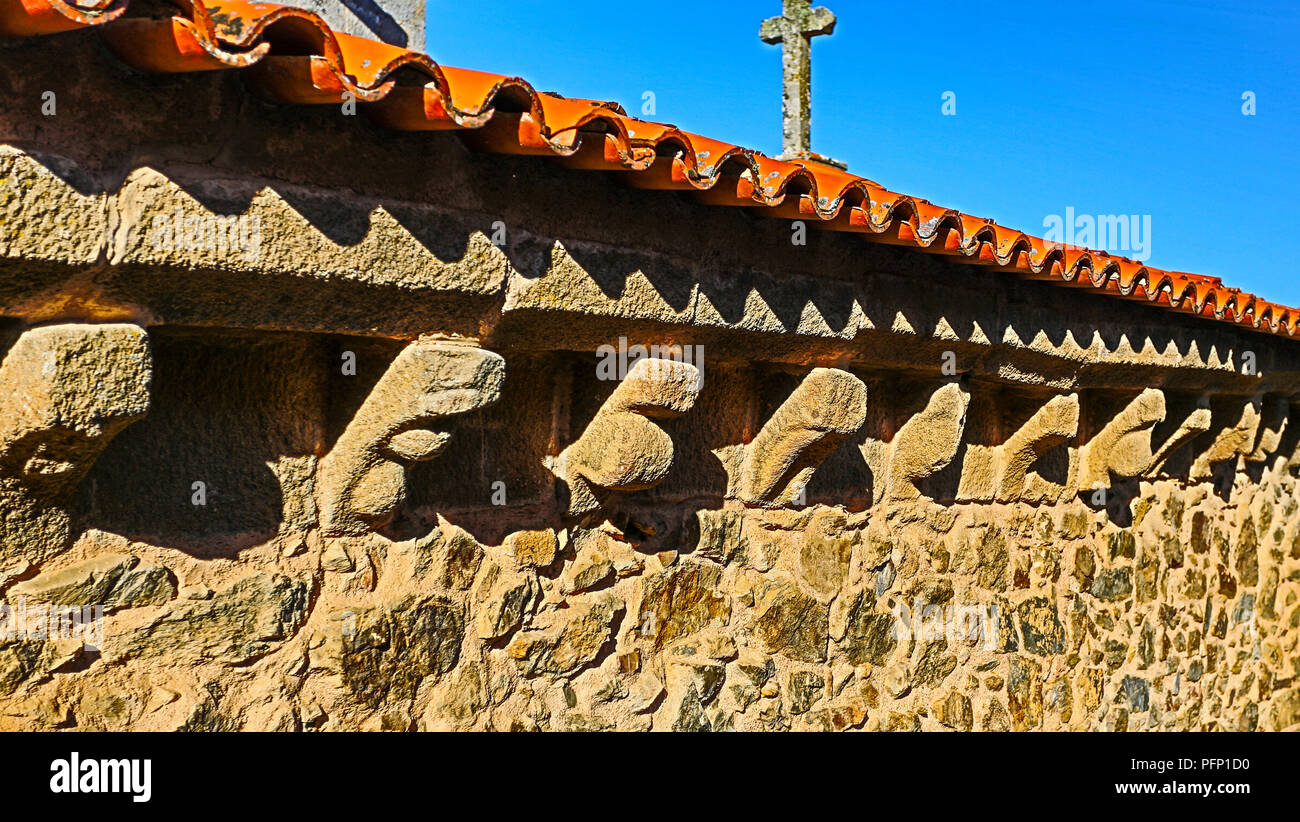 HDR View of the Romanesque cornice corbels (cachorrada) with humans ...