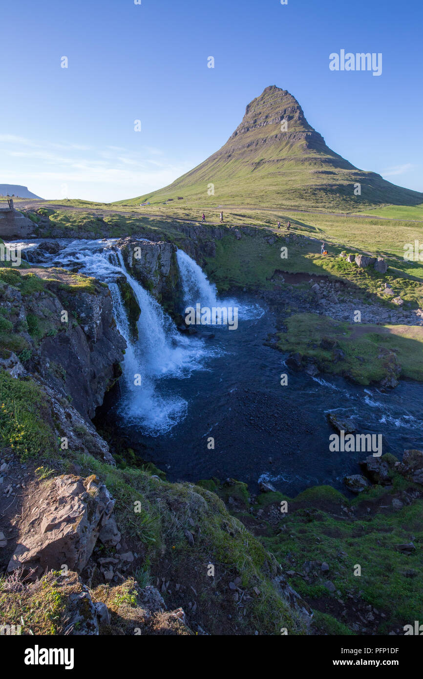 a waterfall in iceland between the mountains from the river spring ...