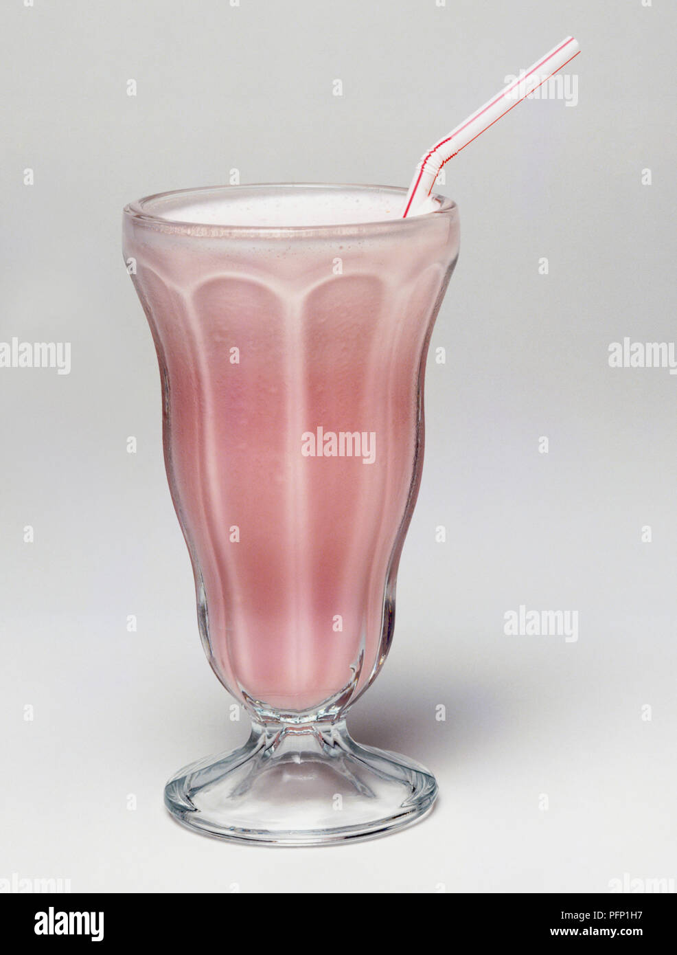 glass of strawberry milkshake with straw Stock Photo - Alamy