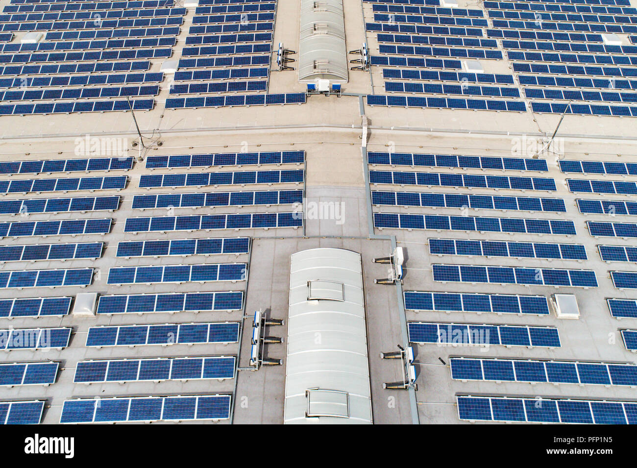 Aerial top down view on many Solar panels rows lined up on of factory ...