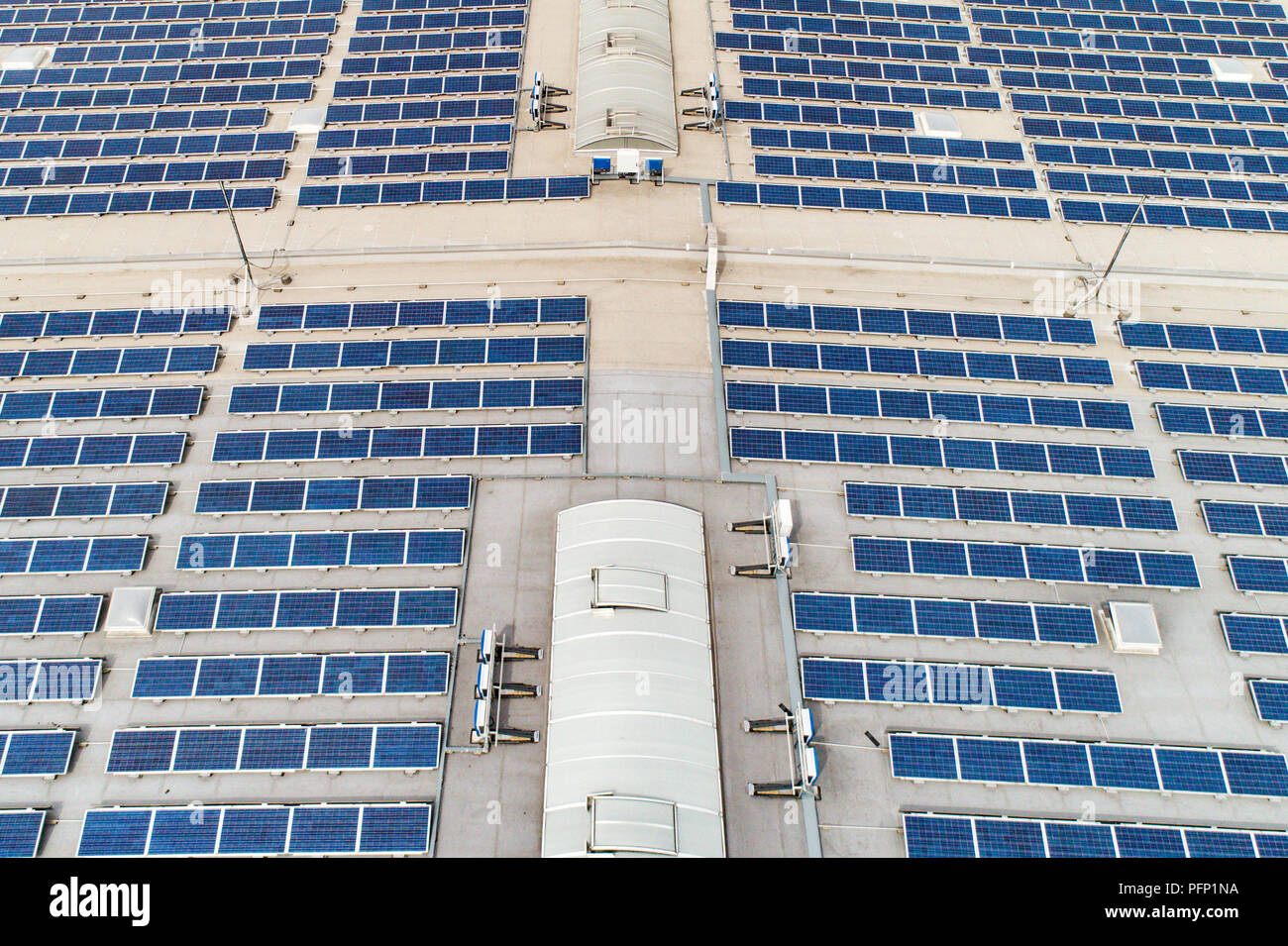 Aerial top down view on many Solar panels rows lined up on of factory ...