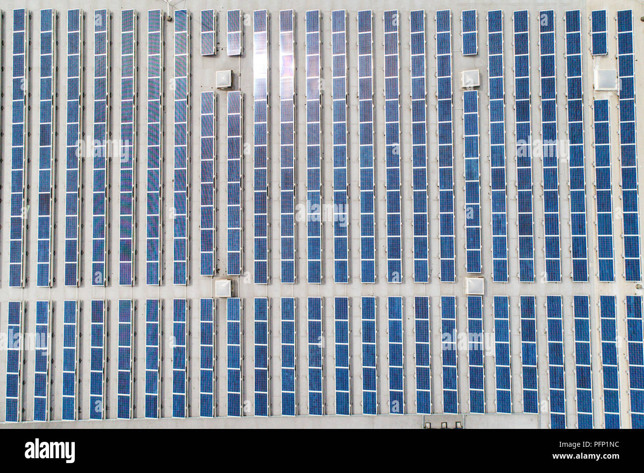 Aerial top down view on many Solar panels rows lined up on of factory ...
