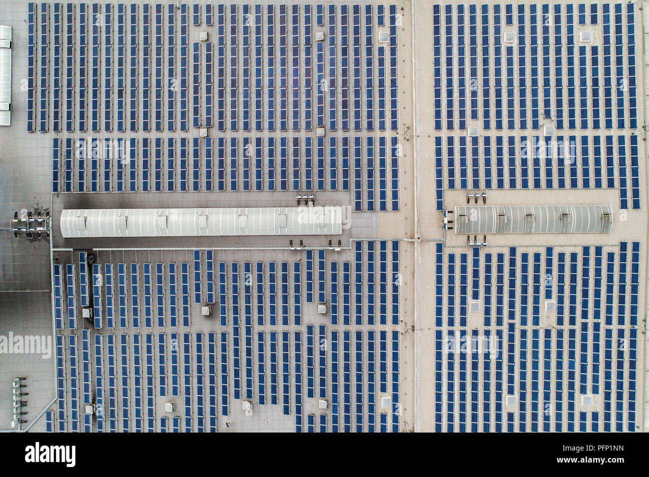 Aerial top down view on many Solar panels rows lined up on of factory ...