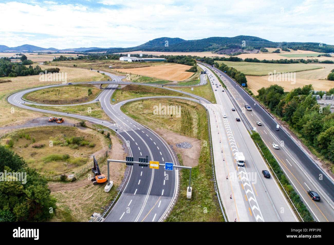 Aerial view of a highway intersection with a clover-leaf interchange in ...
