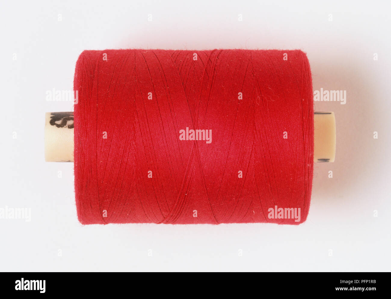Red thread on reel Stock Photo - Alamy