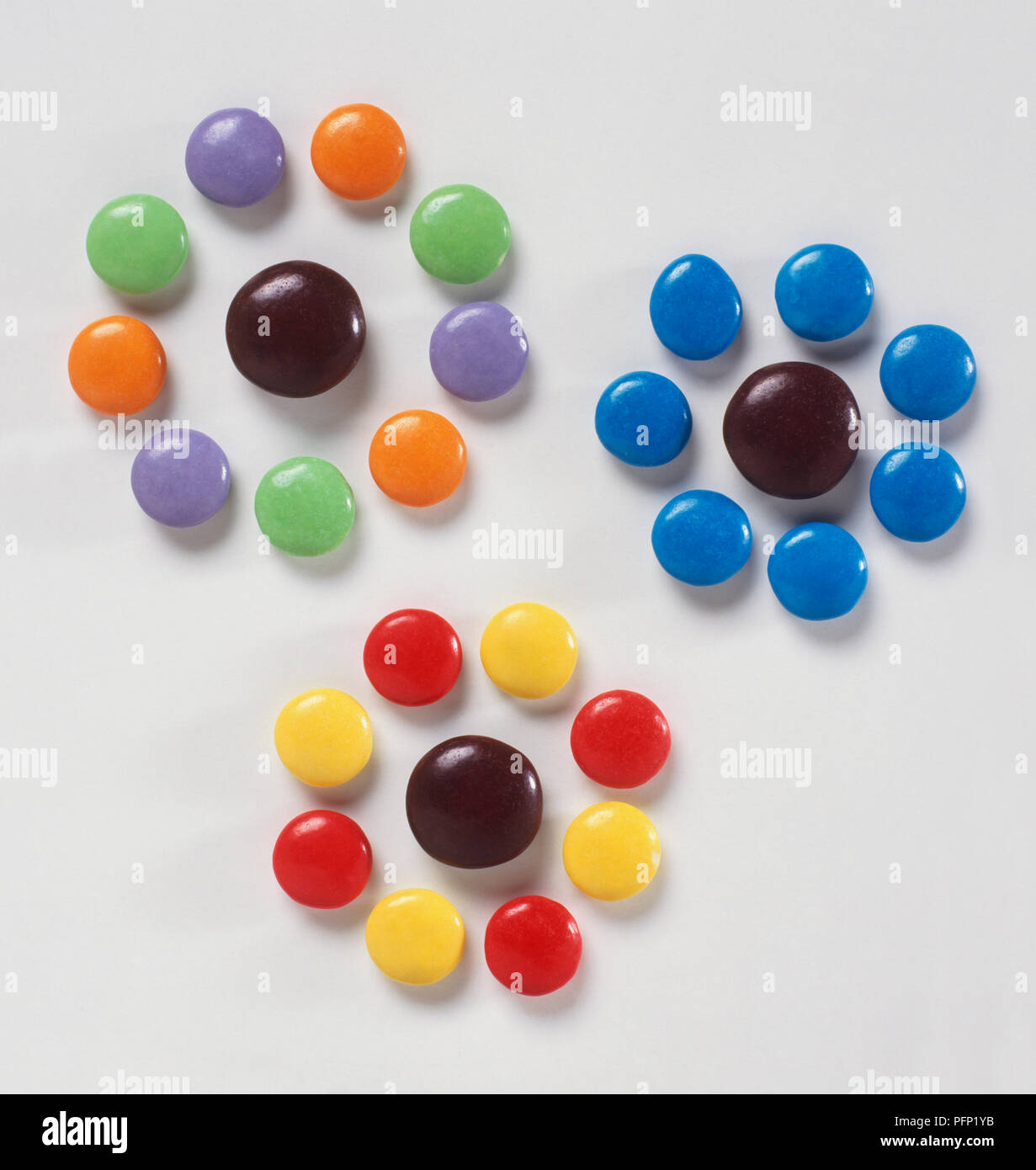 Multi-coloured chocolates arranged in circle Stock Photo - Alamy