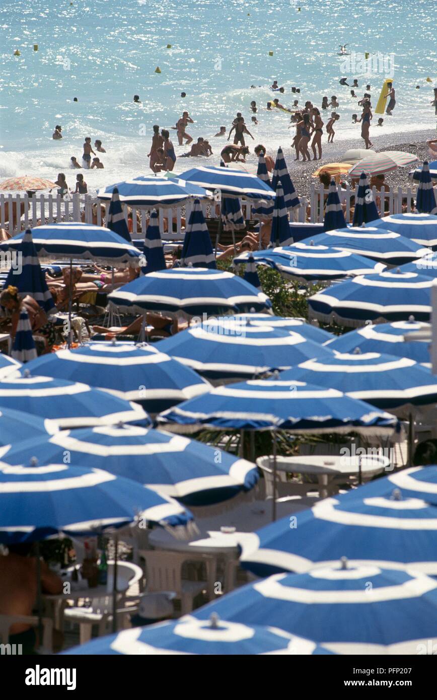 France, Nice, Promenade des Anglais, busy beach with bright blue ...