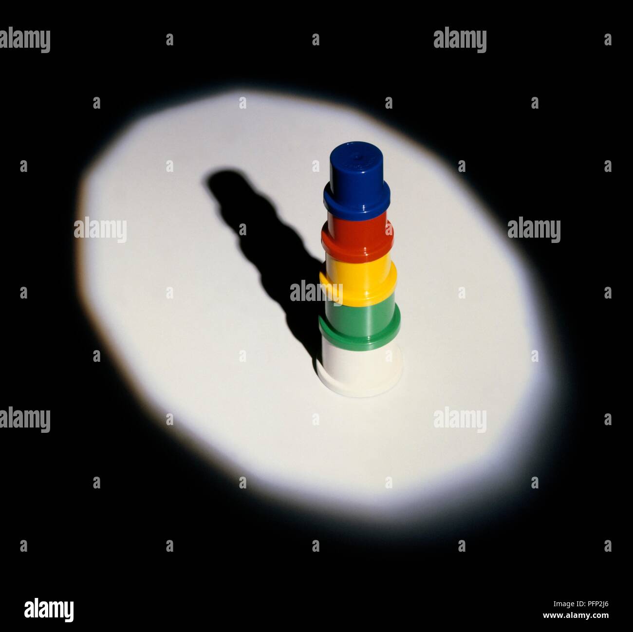 Light illuminating multicoloured object causing black shadow Stock ...