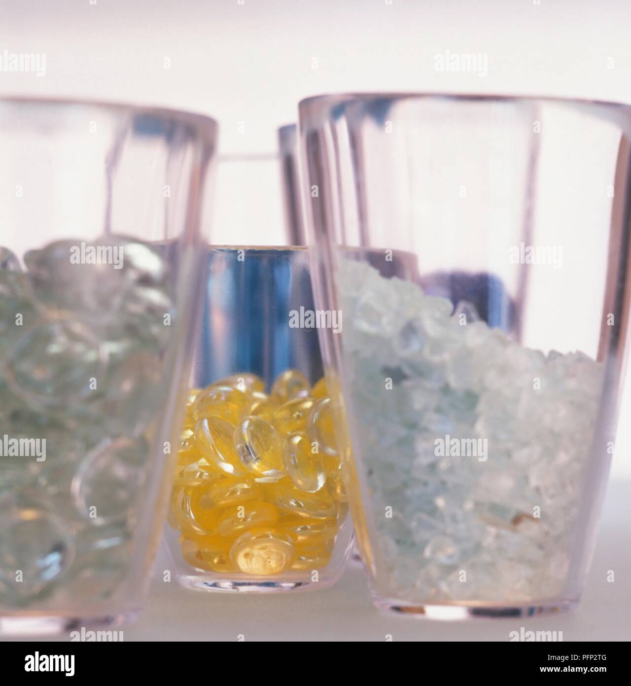 Rough and smooth pebbles in transparent drinking glasses Stock Photo ...