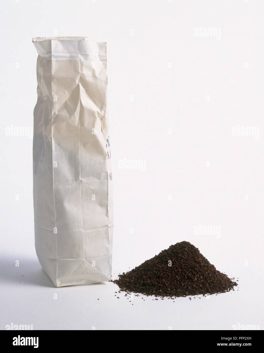 Open white paper bag next to heap of freshly ground coffee Stock Photo ...