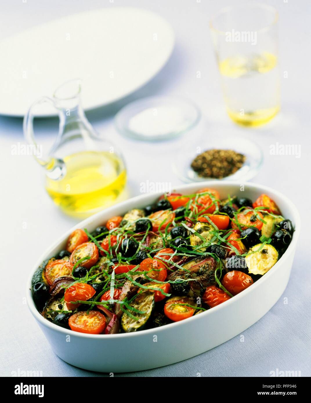 Baked vegetarian dish of roasted vegetables including black olives ...
