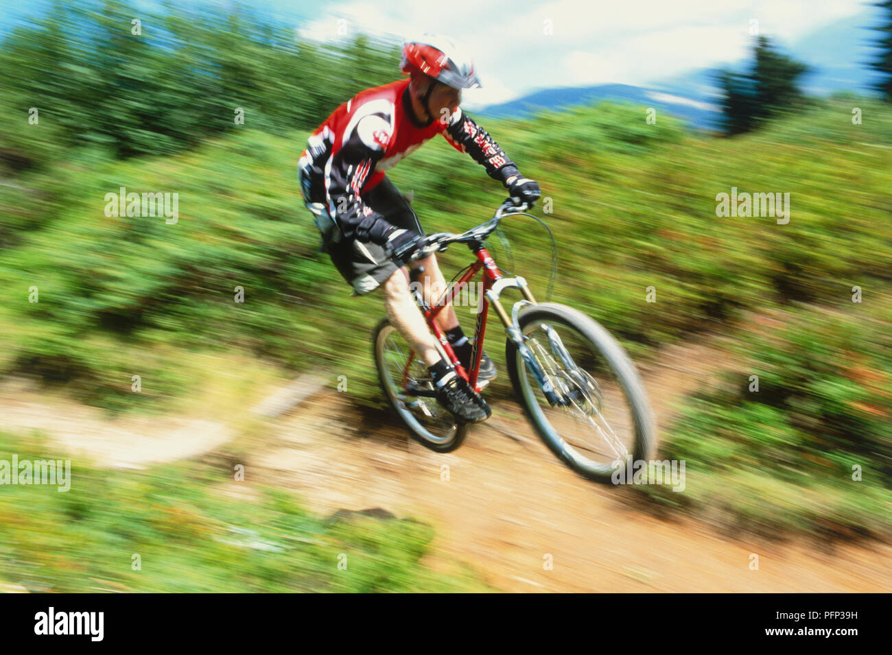 Male cyclist on bike flying through the air Stock Photo - Alamy