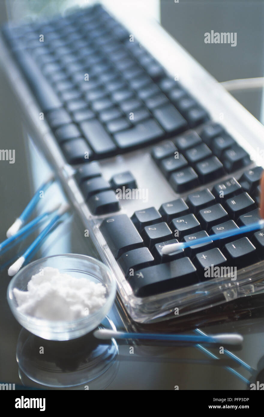 Cotton buds, bowl of baking soda, computer keyboard, close-up Stock ...