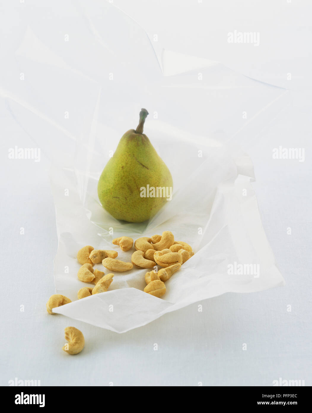 Organic pear and cashew nuts on greaseproof paper Stock Photo - Alamy