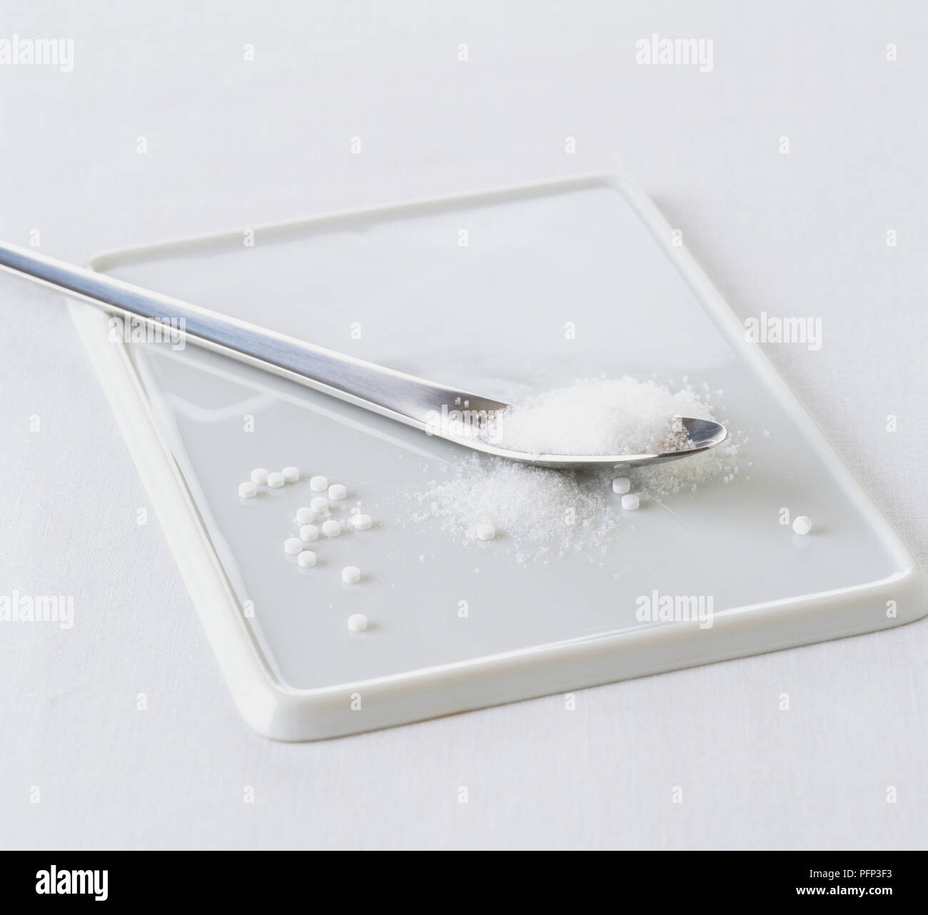 White sugar on spoon and sweeteners on ceramic tray Stock Photo - Alamy
