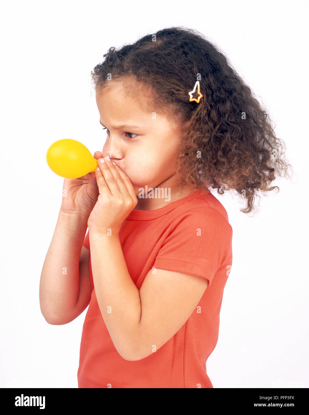 Girl inflating balloon hi-res stock photography and images - Alamy