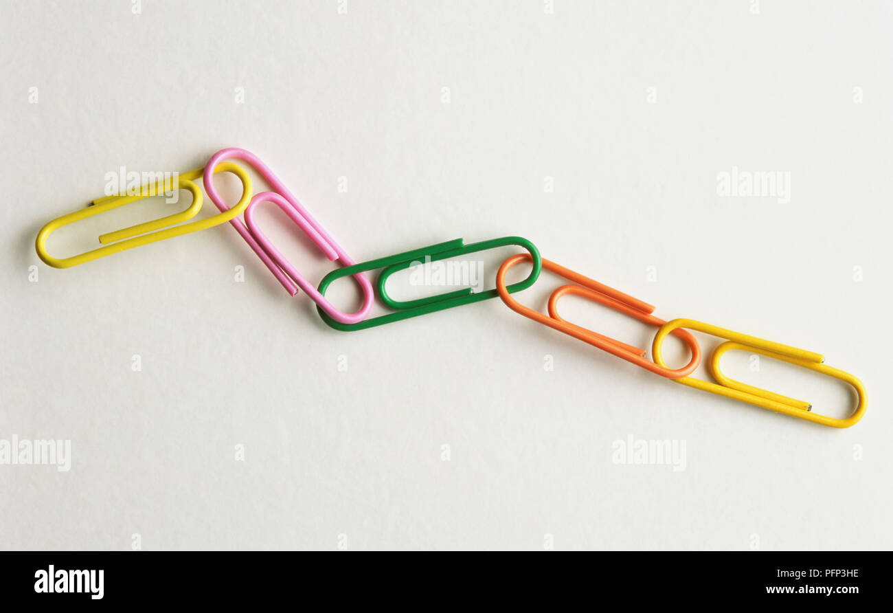Five differently-coloured paperclips joined together into a chain ...
