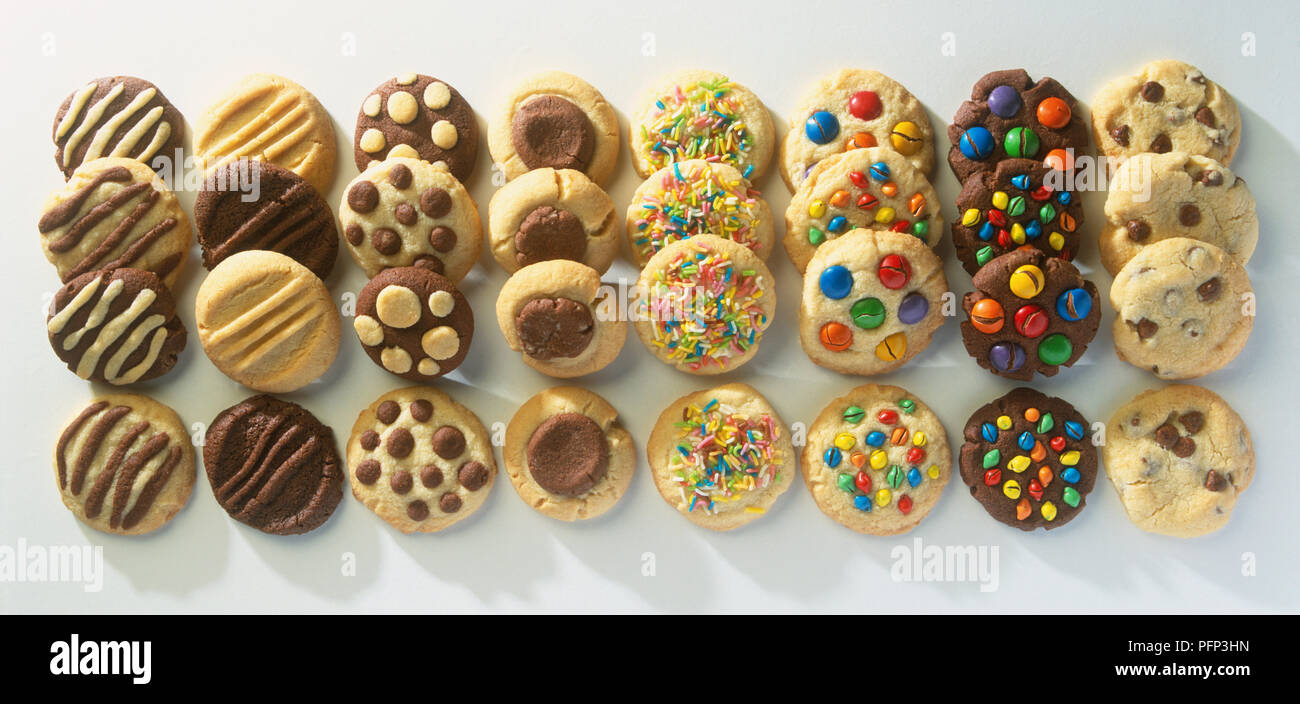 Rows of round biscuits decorated with a selection of sweets Stock Photo ...