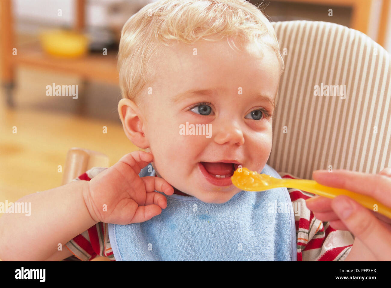 Feeding a baby with a spoon Stock Photo - Alamy