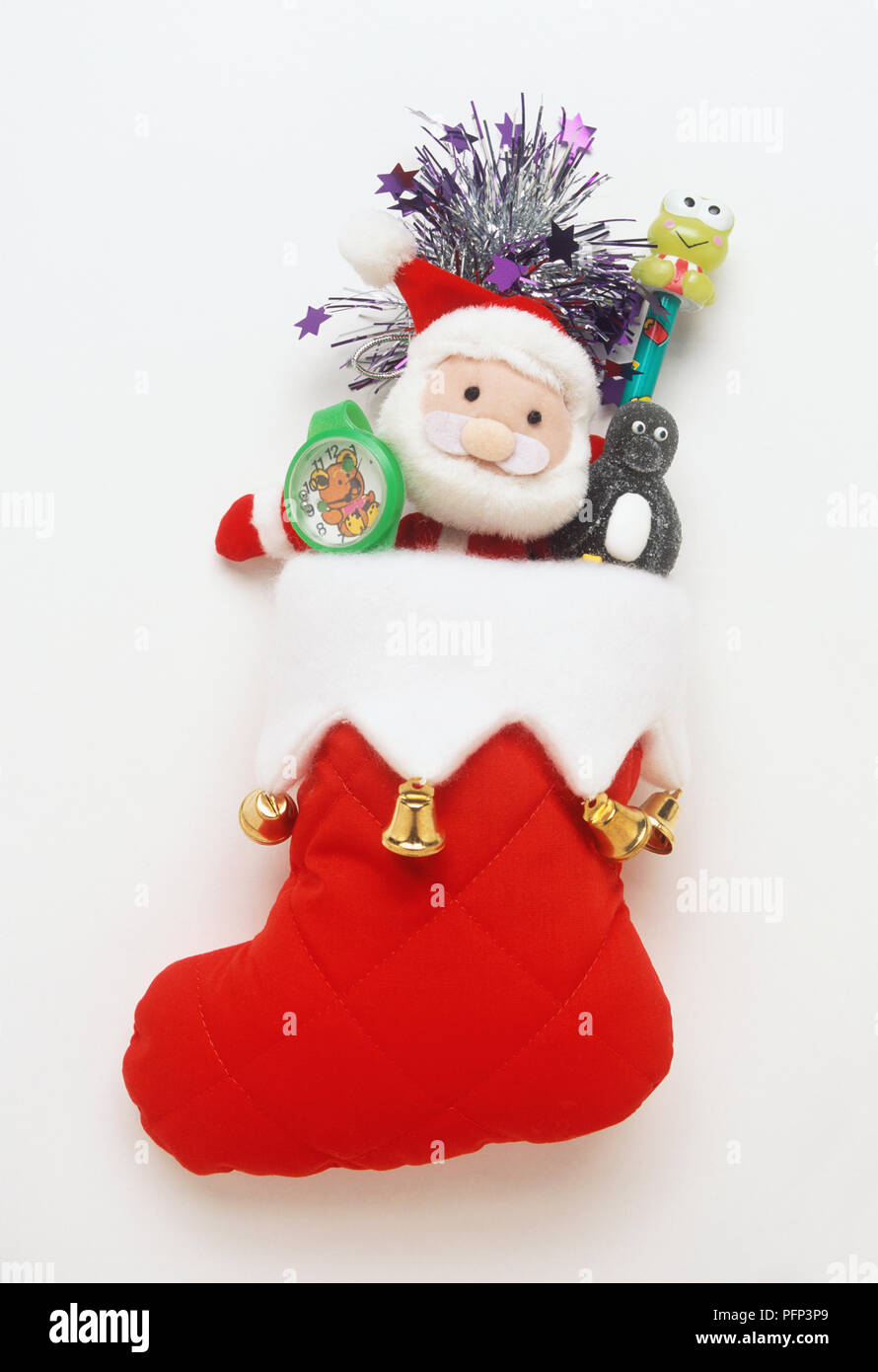Christmas stocking decorated with bells, packed with toys Stock Photo ...