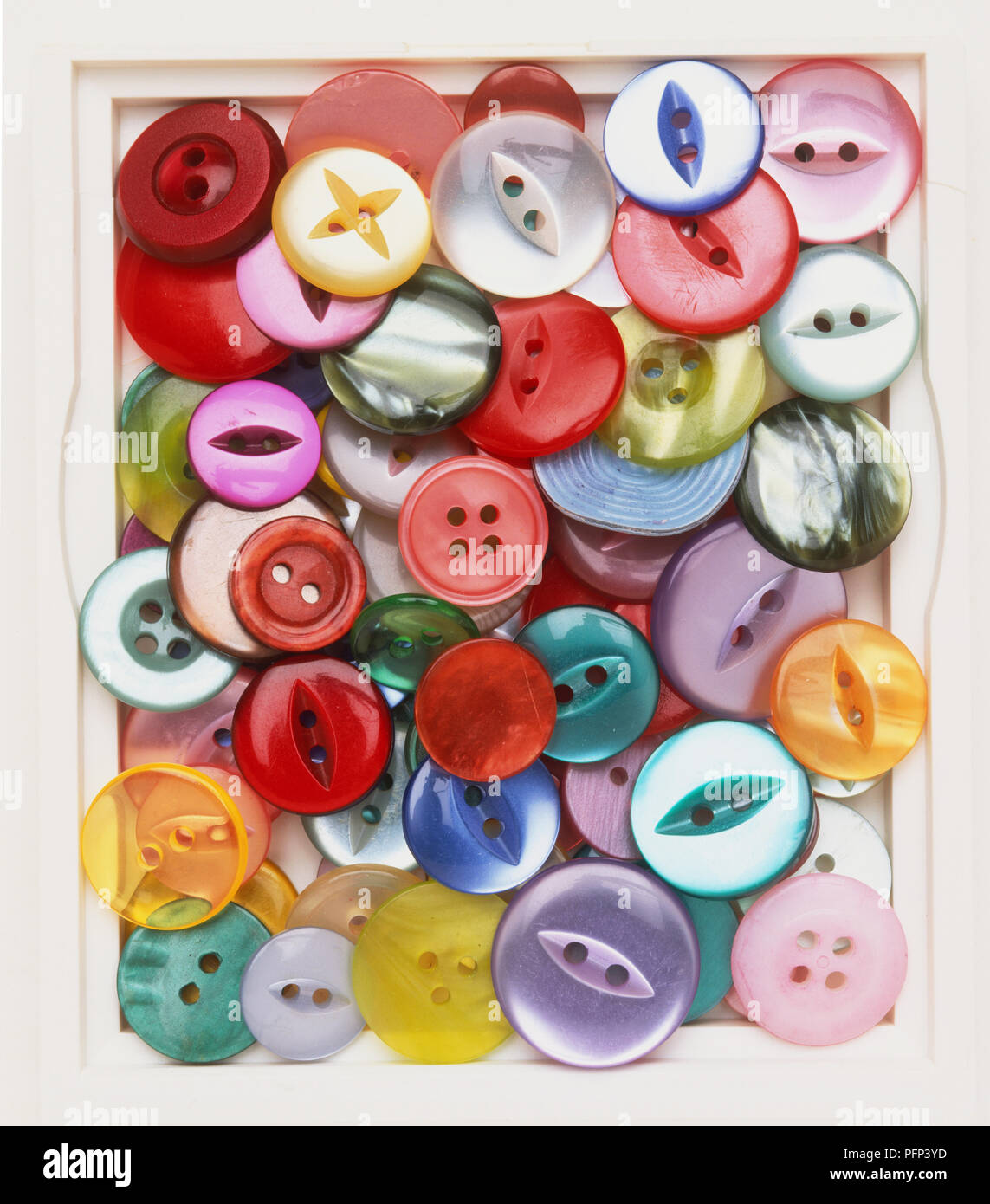 Buttons in many different colours, shapes, and sizes, view from above ...