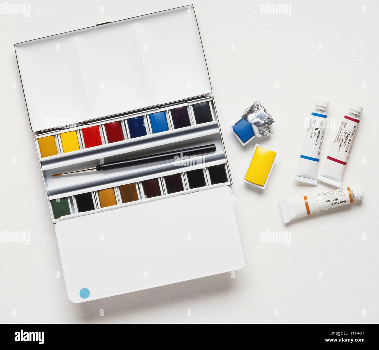 Watercolour paint box with tubes of paint next to it, view from above ...