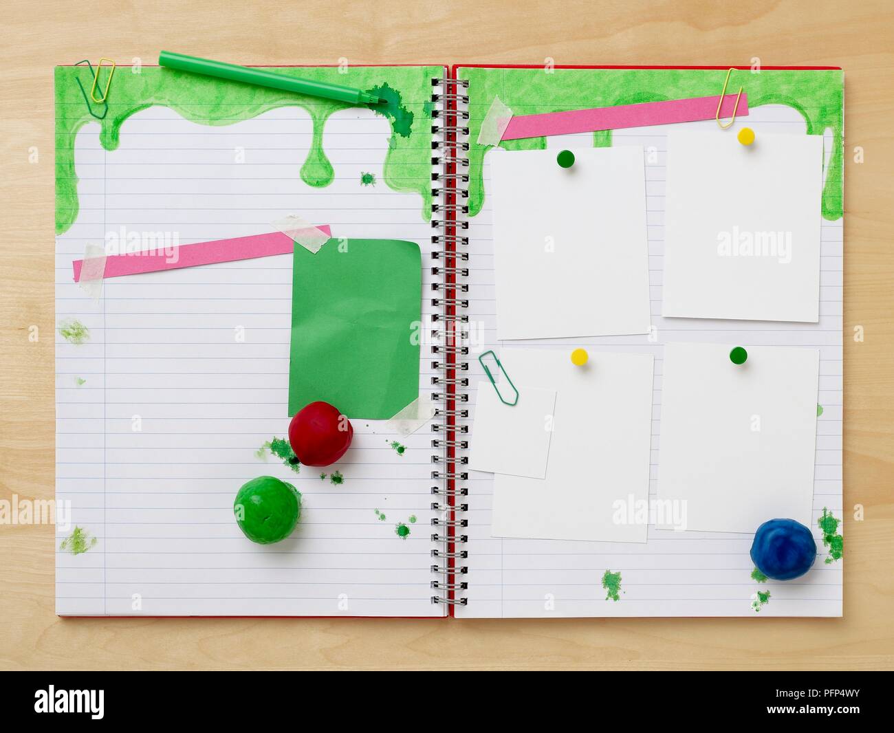 Child's notebook with notes, felt-tip pen and modelling clay on it ...