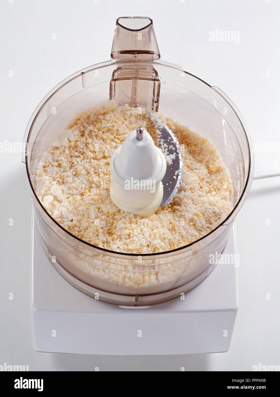 Hazelnut meringue gateau mixture in food processor Stock Photo - Alamy