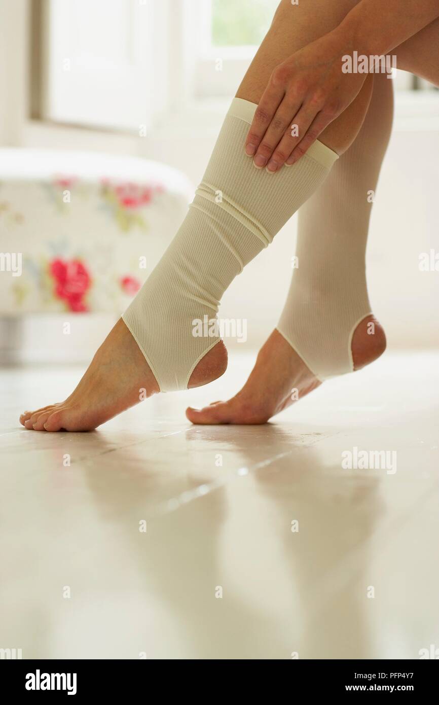 Close-up on woman's feet and calves wearing maternity stockings Stock ...