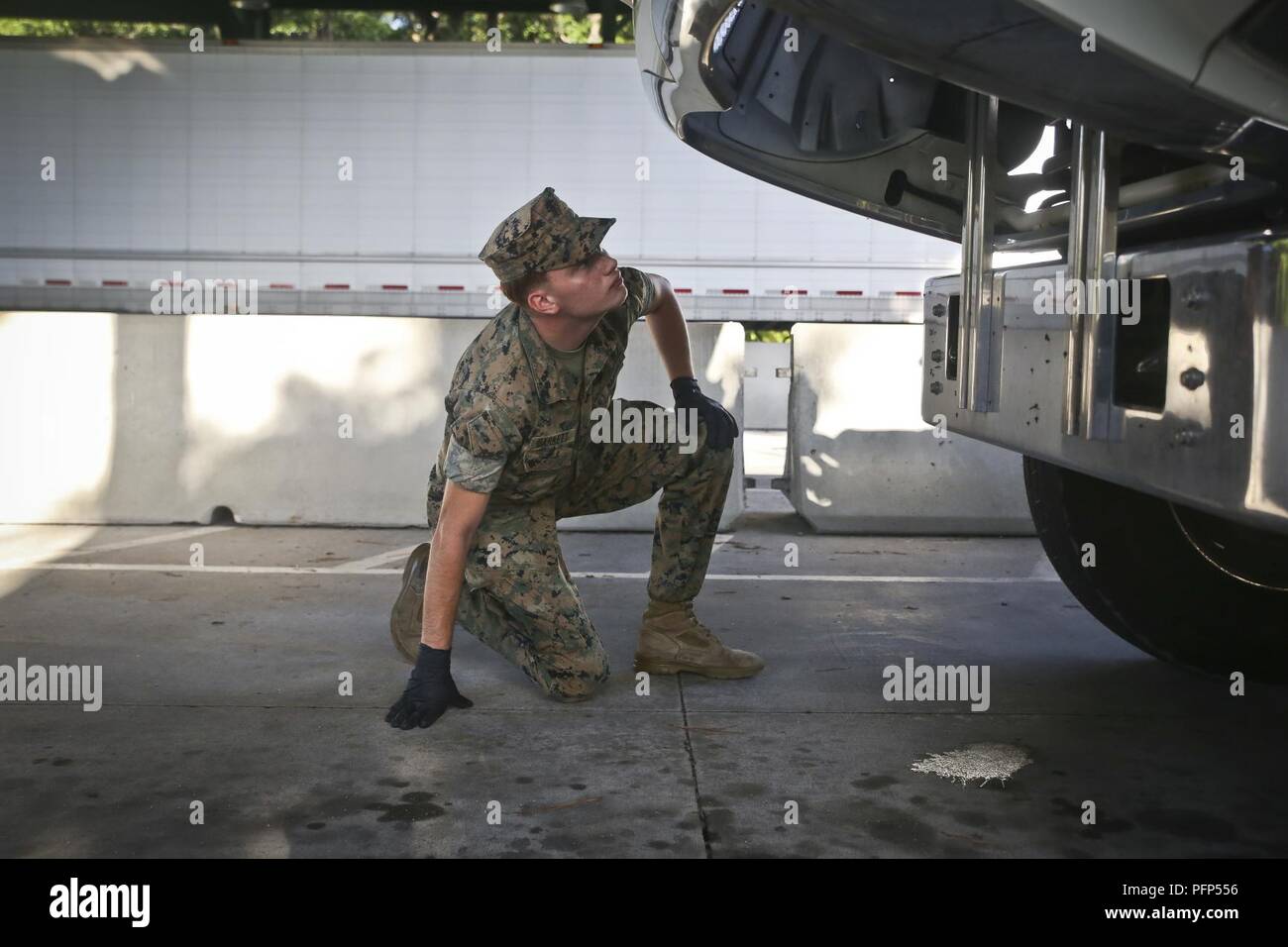 A Marine conducts a vehicle inspection as part of Security Augmentation ...