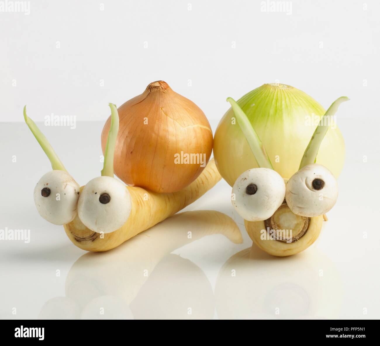 Snails made from raw onions, mushrooms and parsnips Stock Photo - Alamy