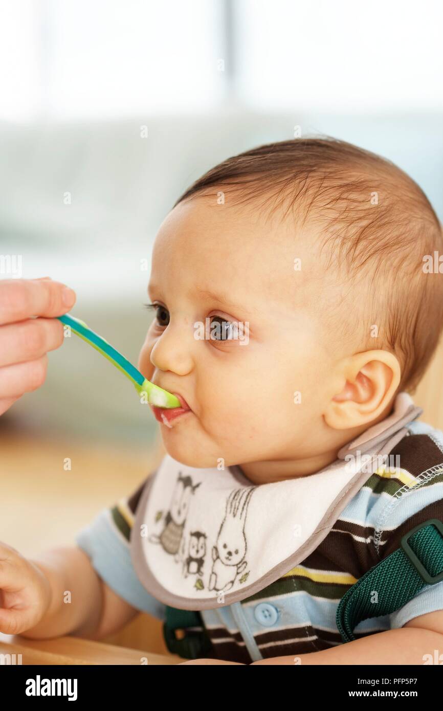 Baby boy being fed with spoon, close-up Stock Photo - Alamy