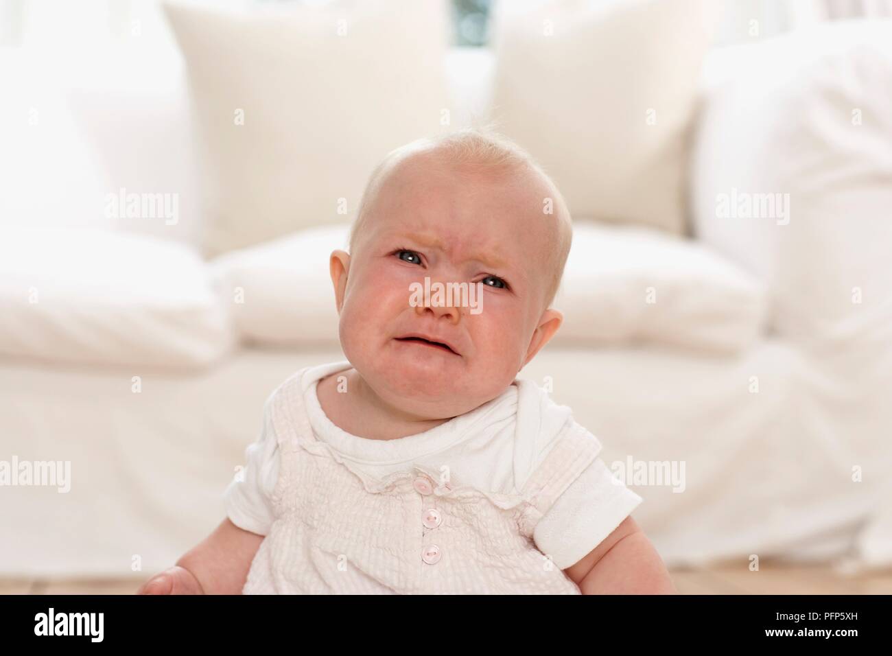 Baby girl crying, head and shoulders, front view Stock Photo - Alamy