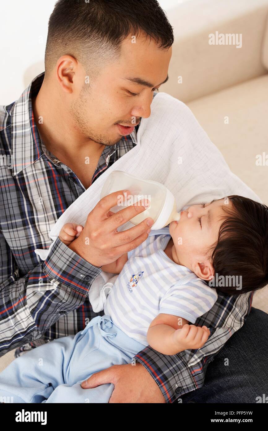 Man bottle feeding baby boy, close-up Stock Photo - Alamy