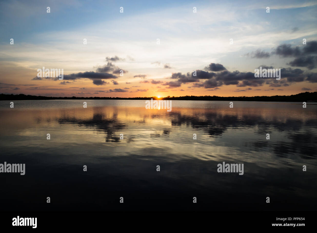 Sunset with fluffy clouds at the lagoon in Utila, Honduras, Central ...