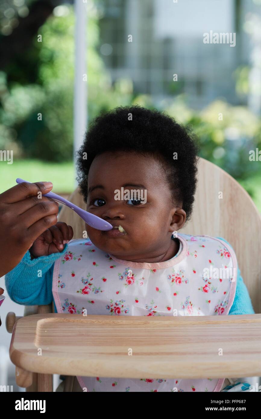 Baby being fed high chair hi-res stock photography and images - Alamy