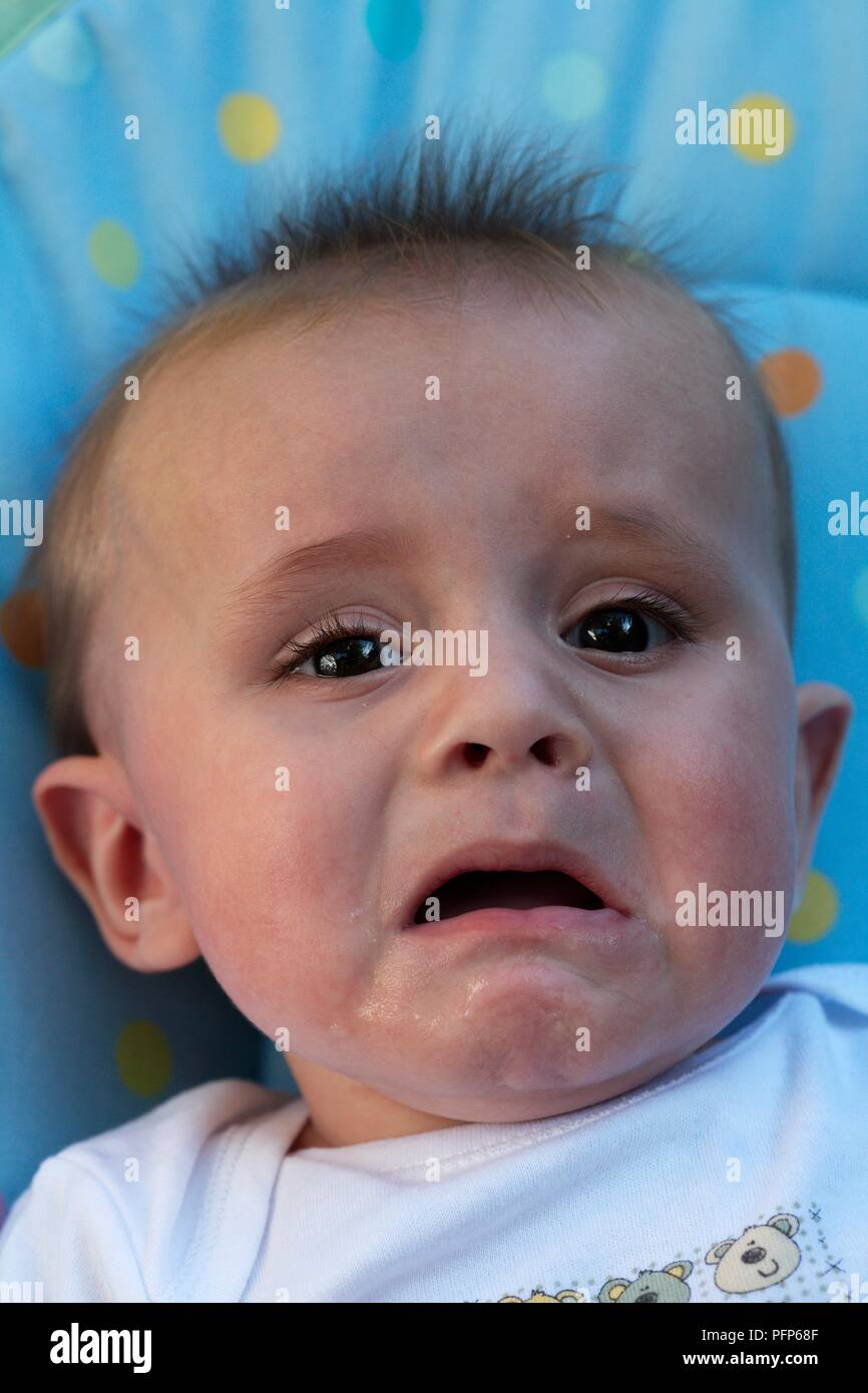 Head and shoulders of a baby boy crying, front view Stock Photo - Alamy