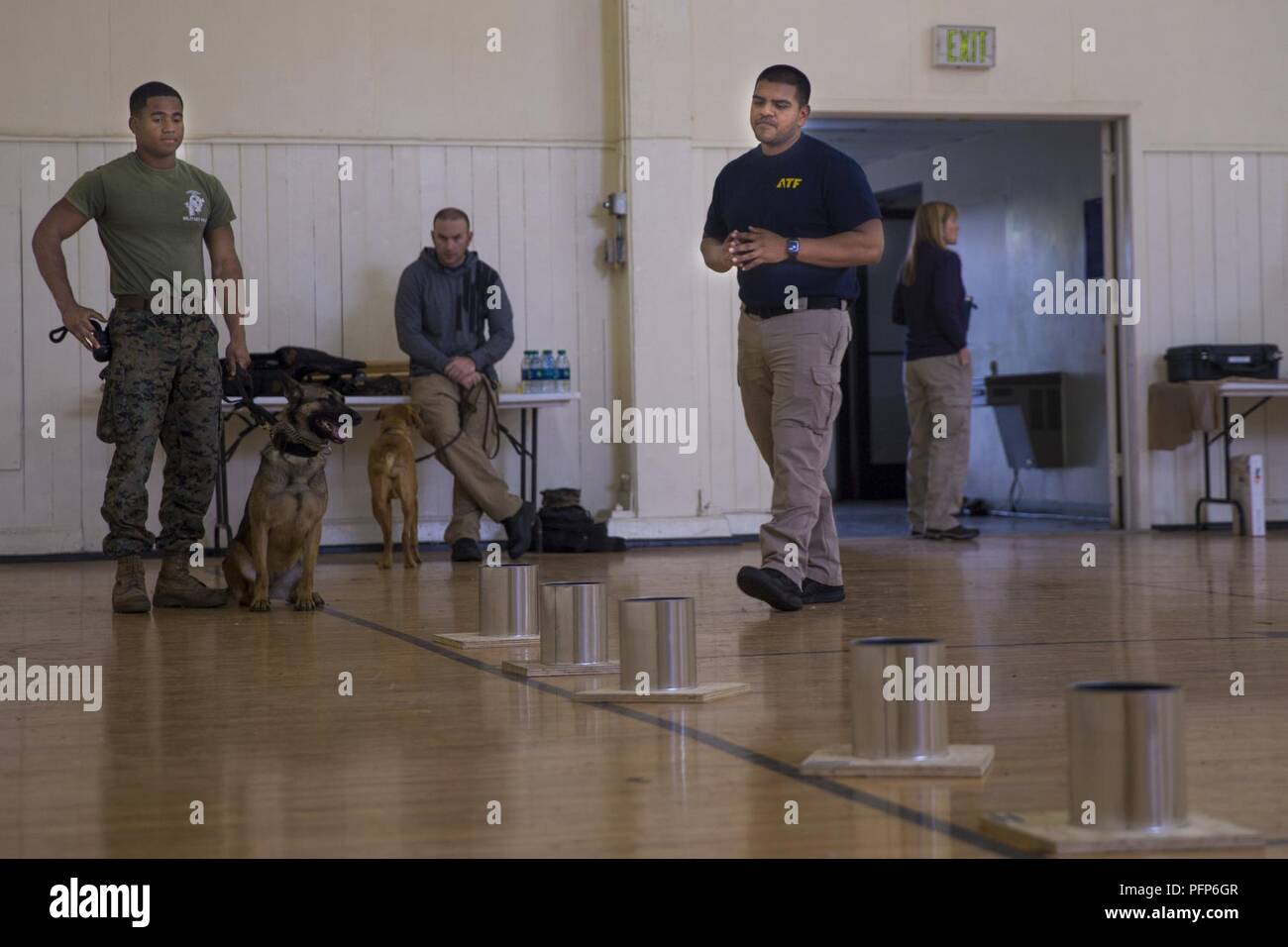 Alfredo Guajardo, right, Bureau of Alcohol, Tobacco, Firearms and Explosives canine trainer ...