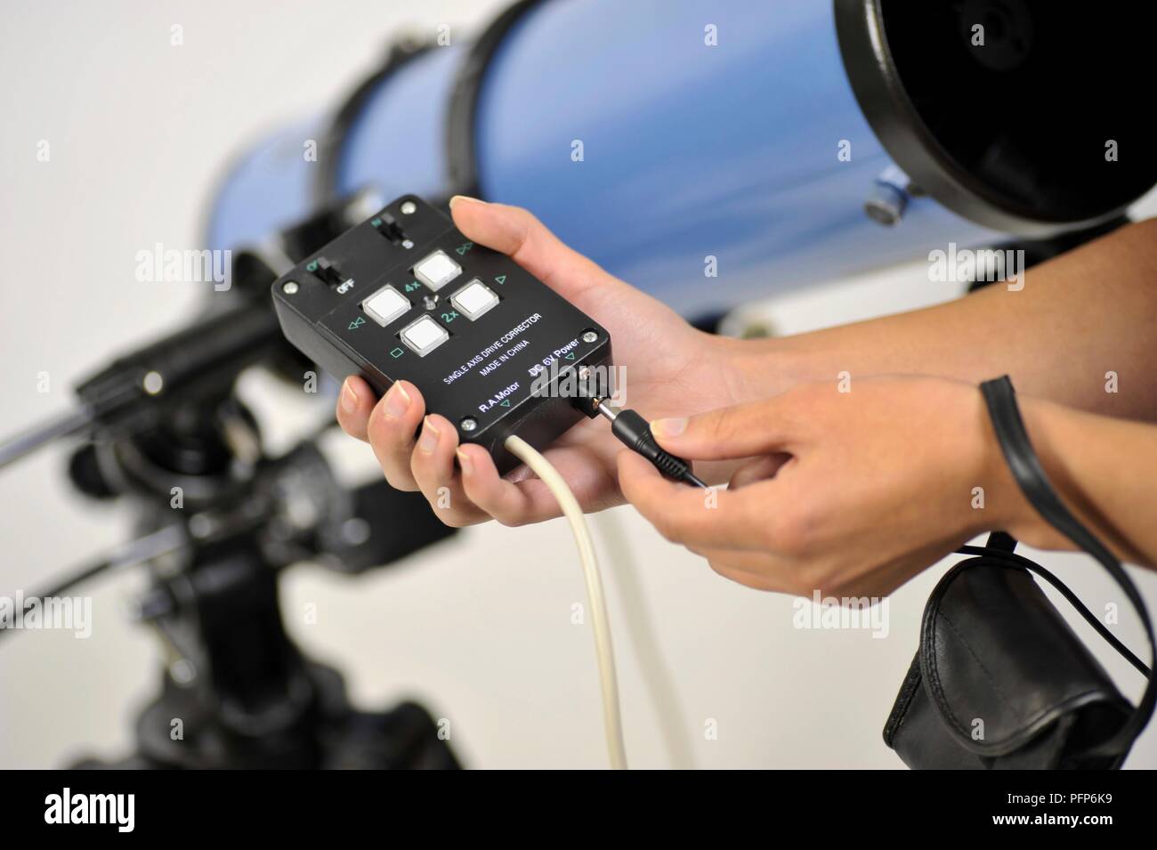 Connecting telescope to power supply, close-up Stock Photo - Alamy