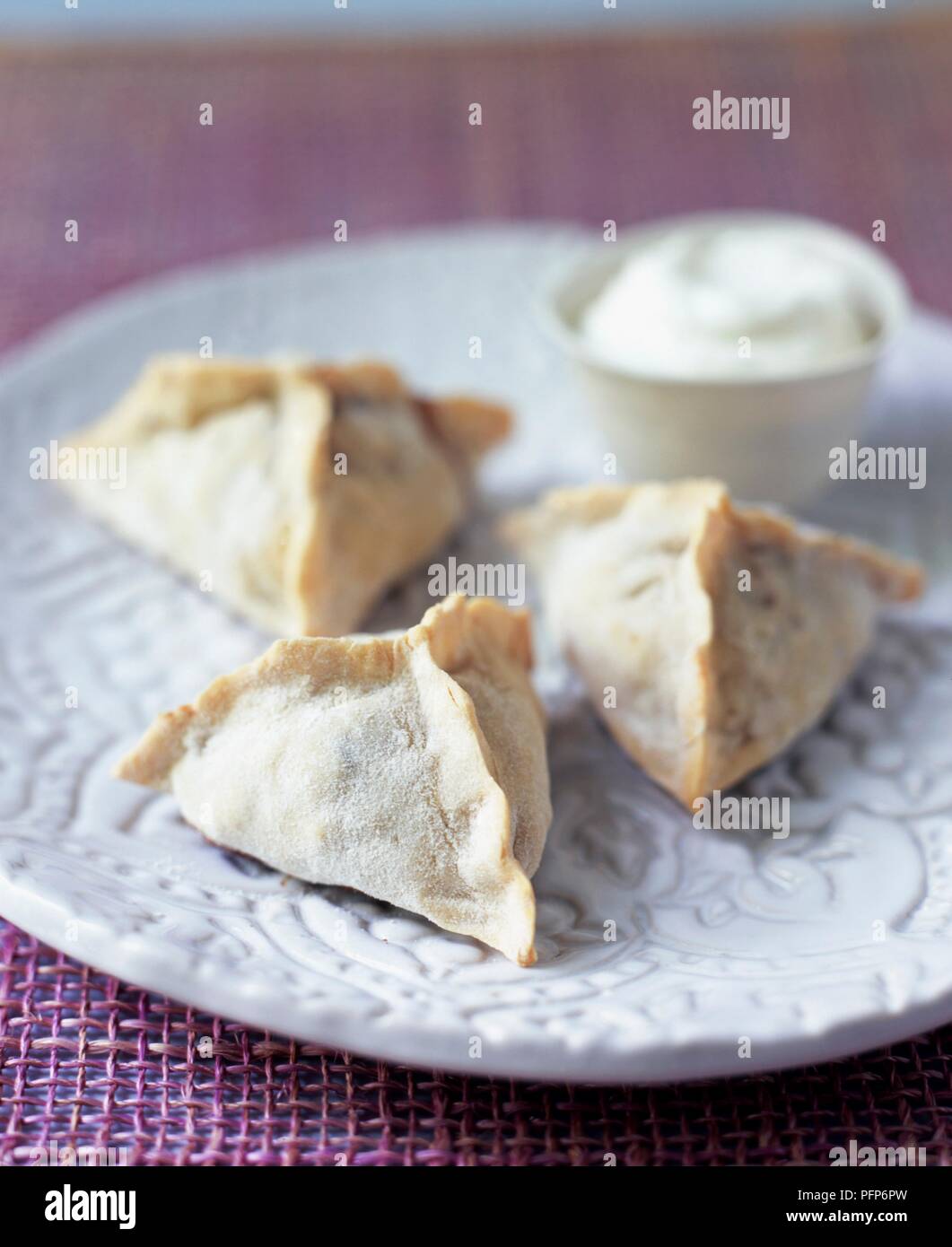 Fatayer Bisabanikh, Lebanese spinach pastry parcels on plate, with ...