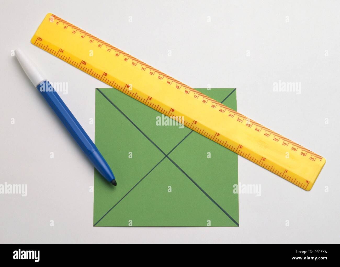 Utensils for making a paper windmill, ruler, felt-tip pen and piece of ...