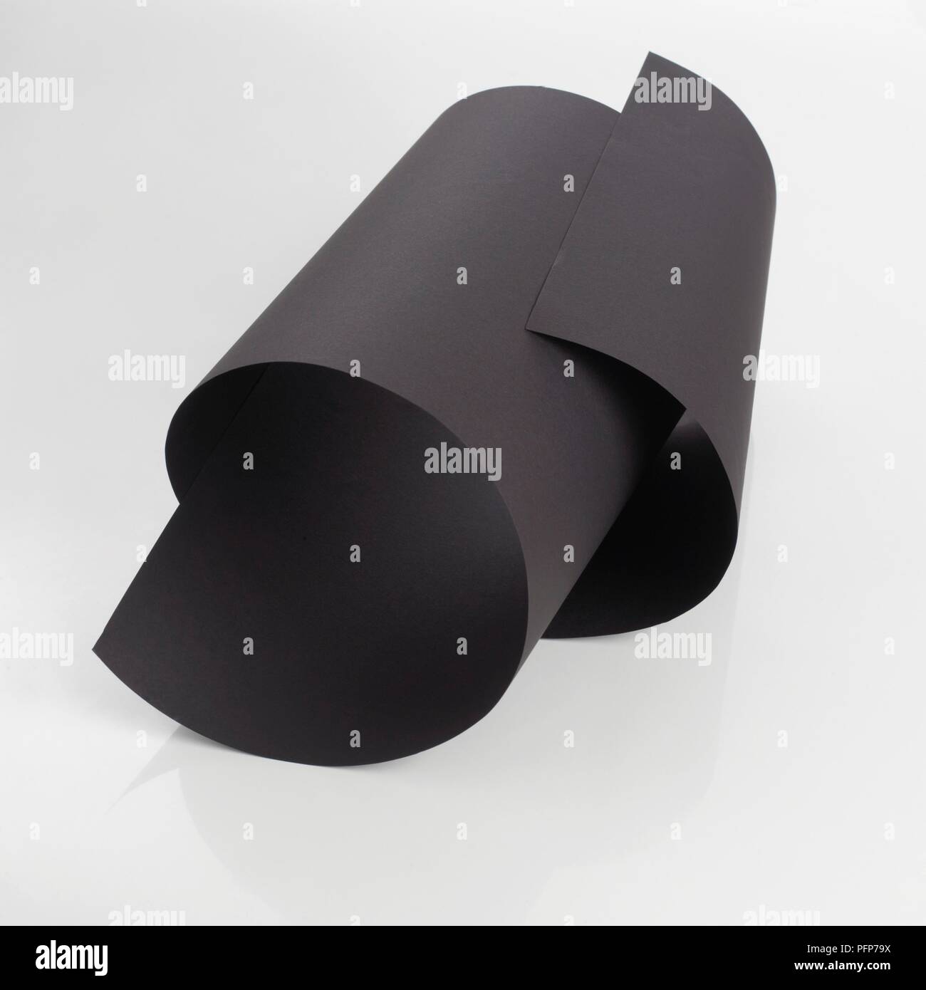 Rolled up black paper Stock Photo - Alamy