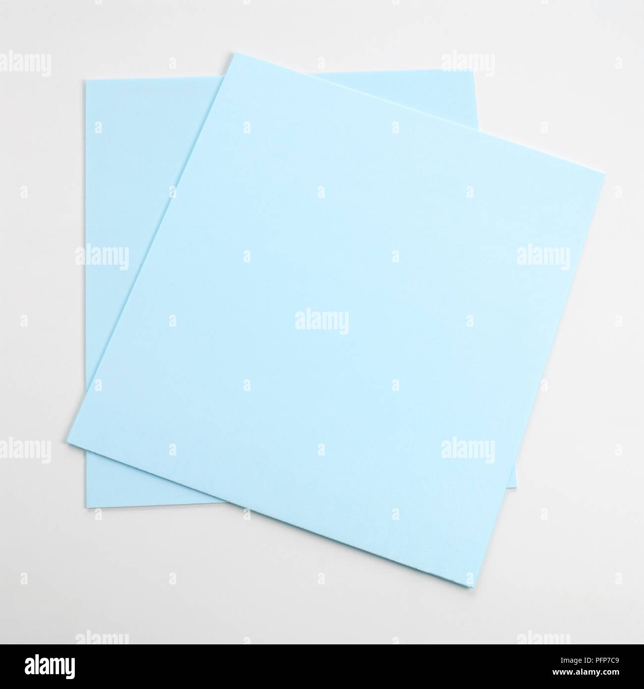 Two pieces of blue paper Stock Photo - Alamy