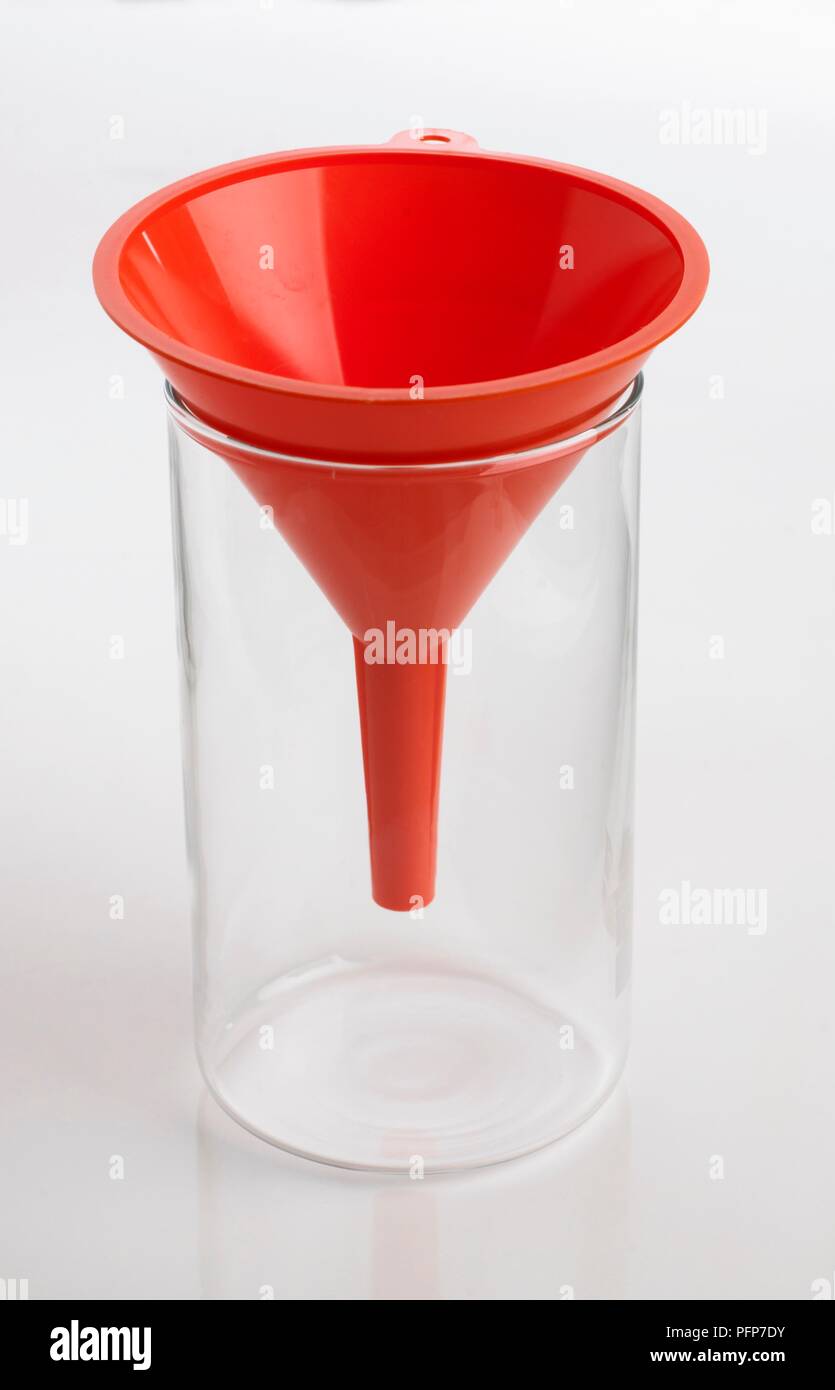 Red plastic funnel in glass beaker Stock Photo - Alamy