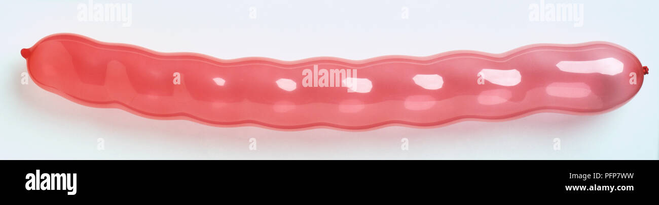 Long red balloon Stock Photo - Alamy